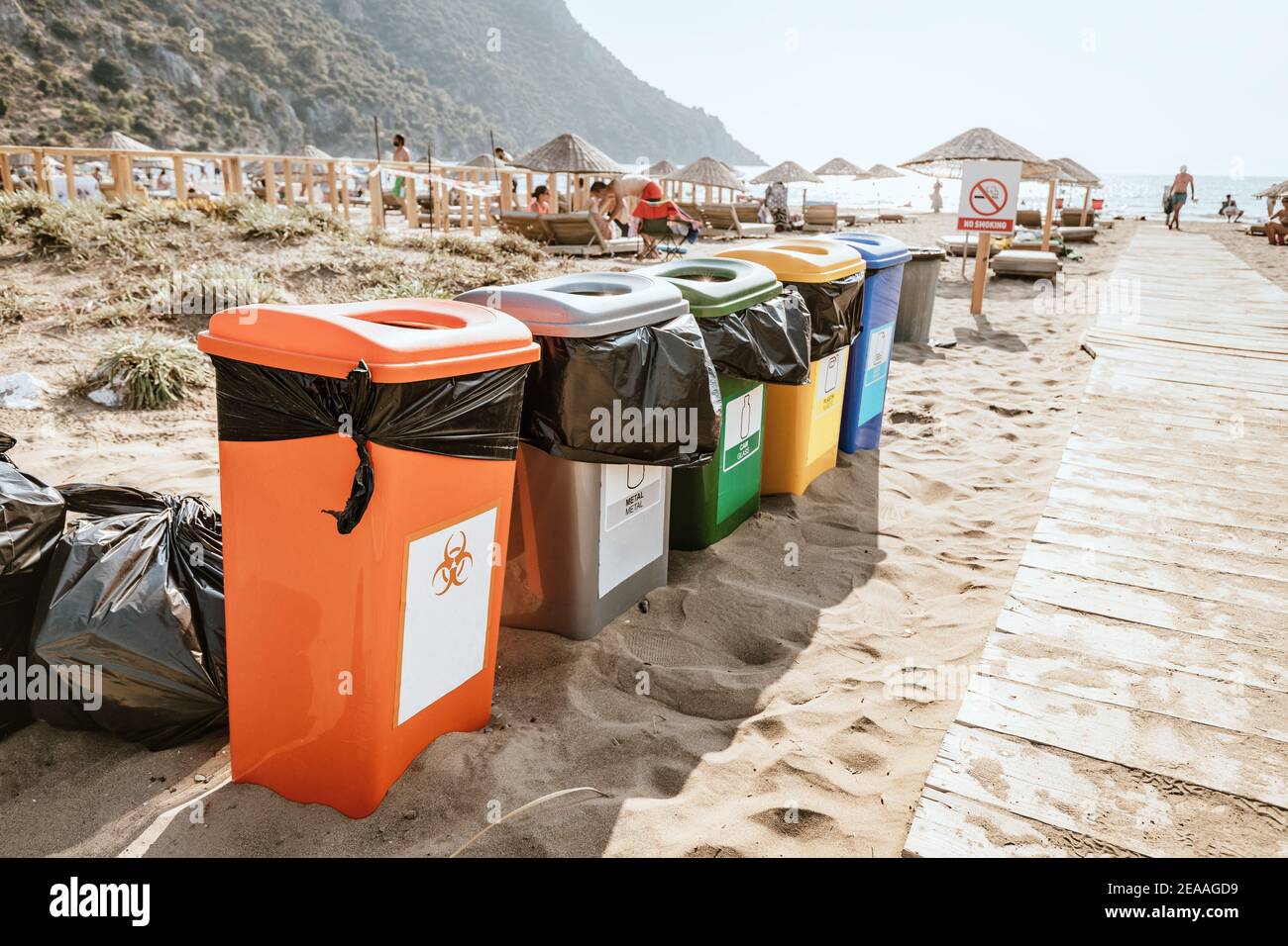 separate collection of garbage and waste on a public beach as an ...
