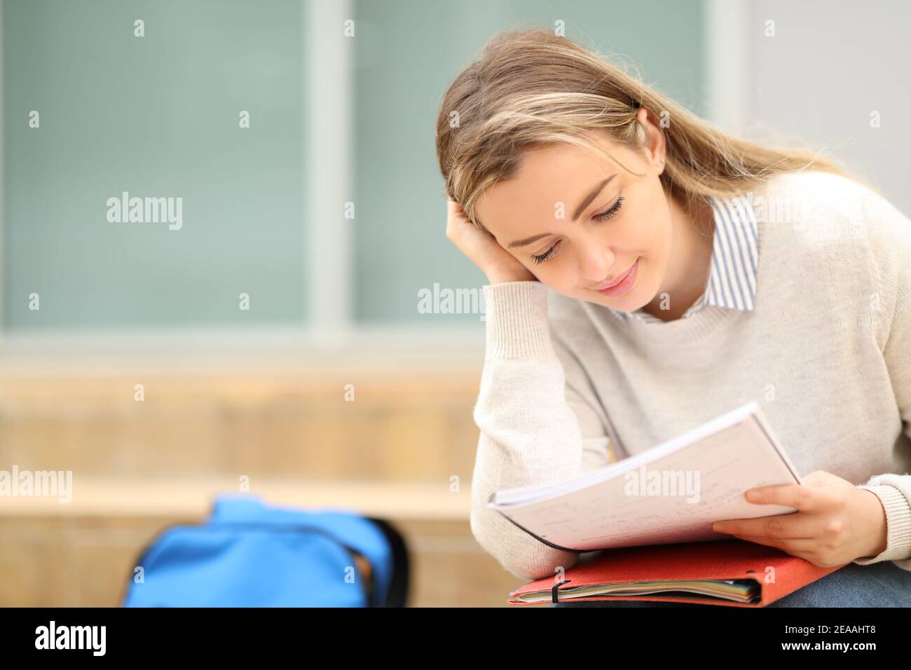 Concentrated student studying memorizing notes sitting in a campus ...