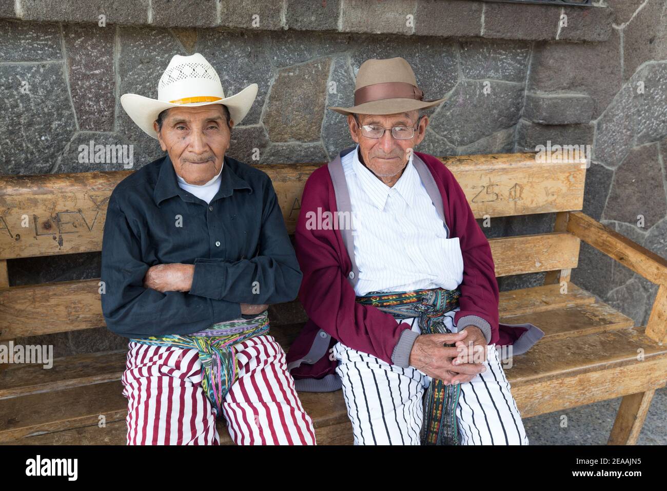 Two indigenous men sitting in front of the town hall Stock Photo - Alamy