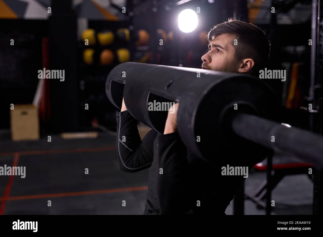 muscular man raising heavy weights, training pumping arm muscles ...