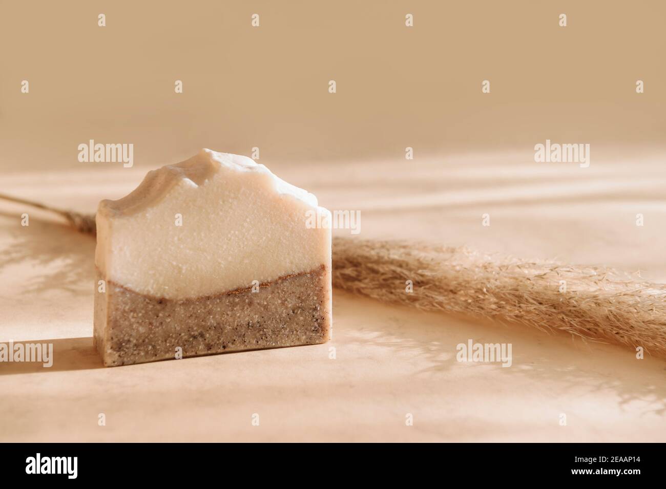 Handmade soap and pampas grass. Sunshade shadow on beige background ...