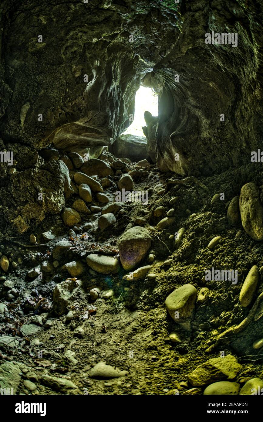 Cave entrance with pebbles Stock Photo - Alamy