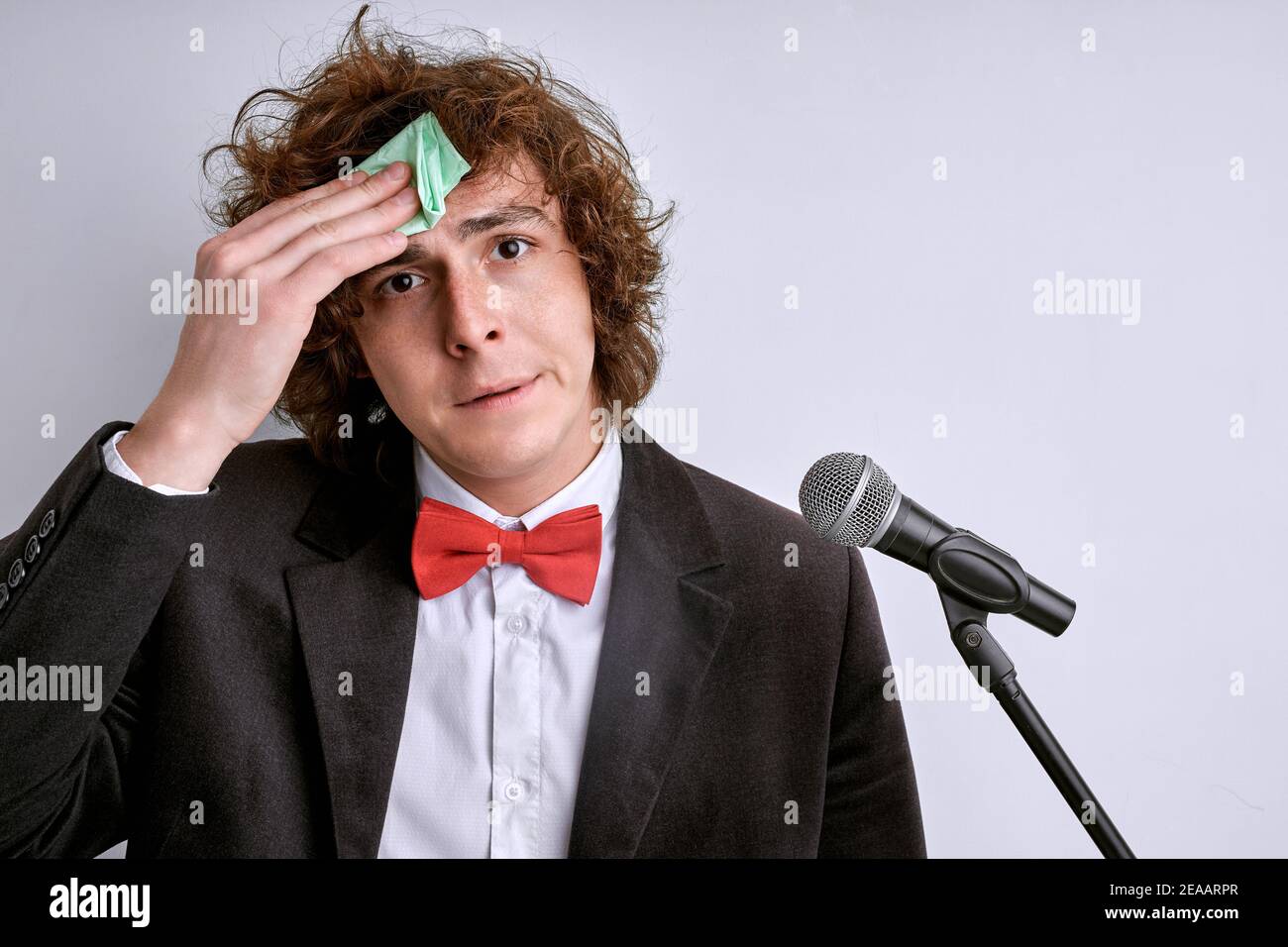 sweaty male is afraid of bad presentation. stressed man with microphone ...