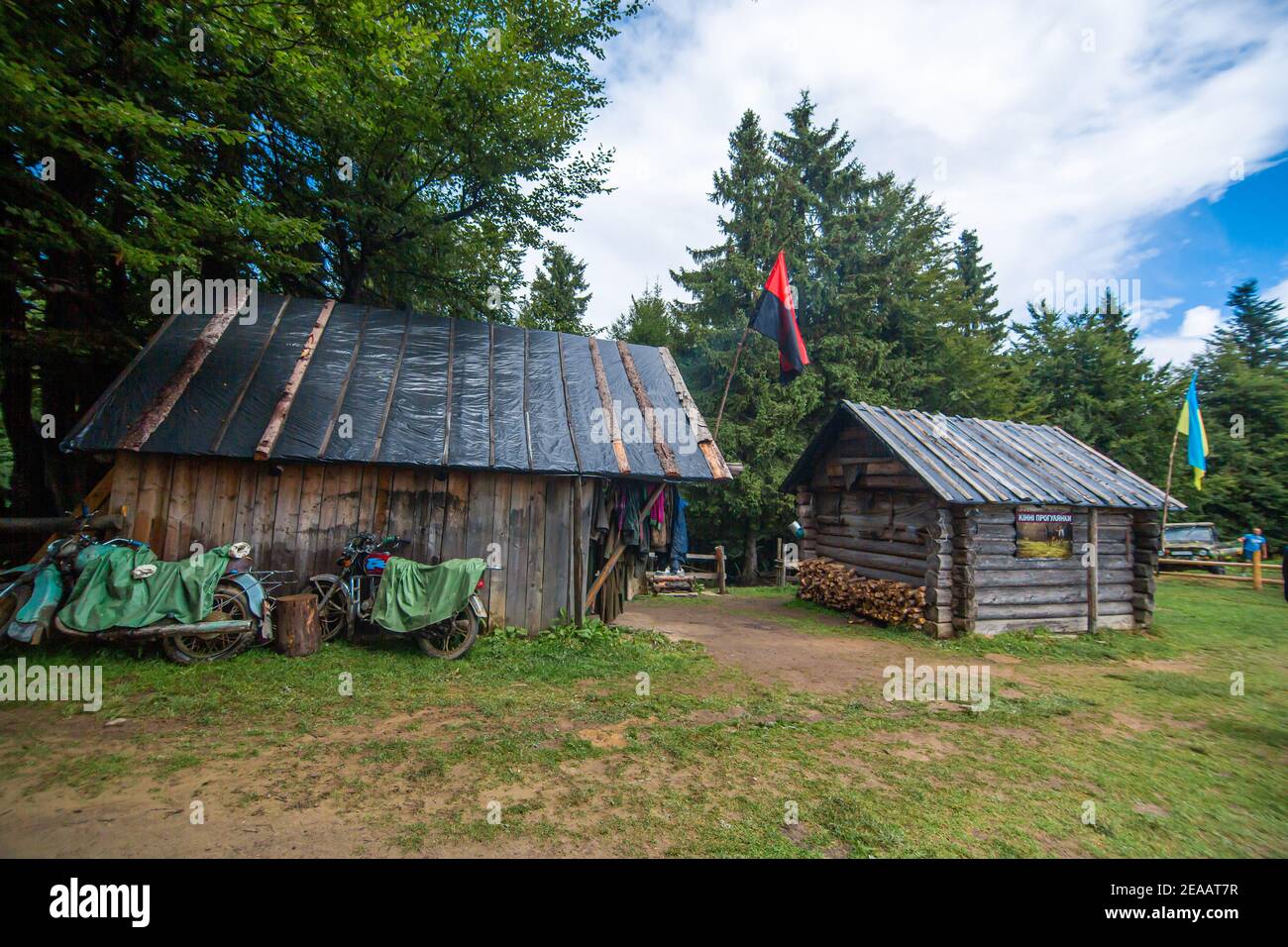 Wooden log huts of farm in mountain forest Stock Photo - Alamy