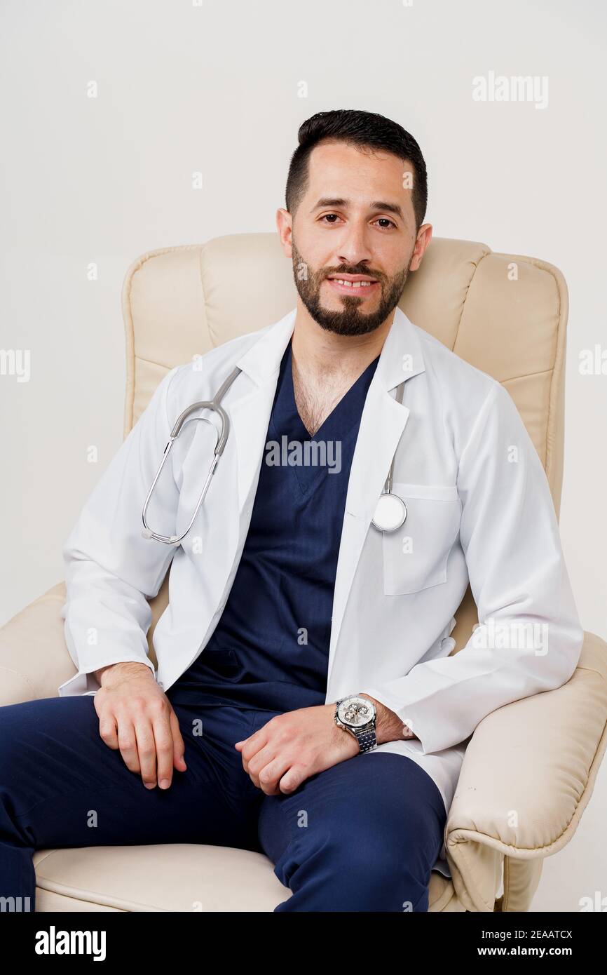 Arabian doctor surgeon in medical robe with phonendoscope seats in ...
