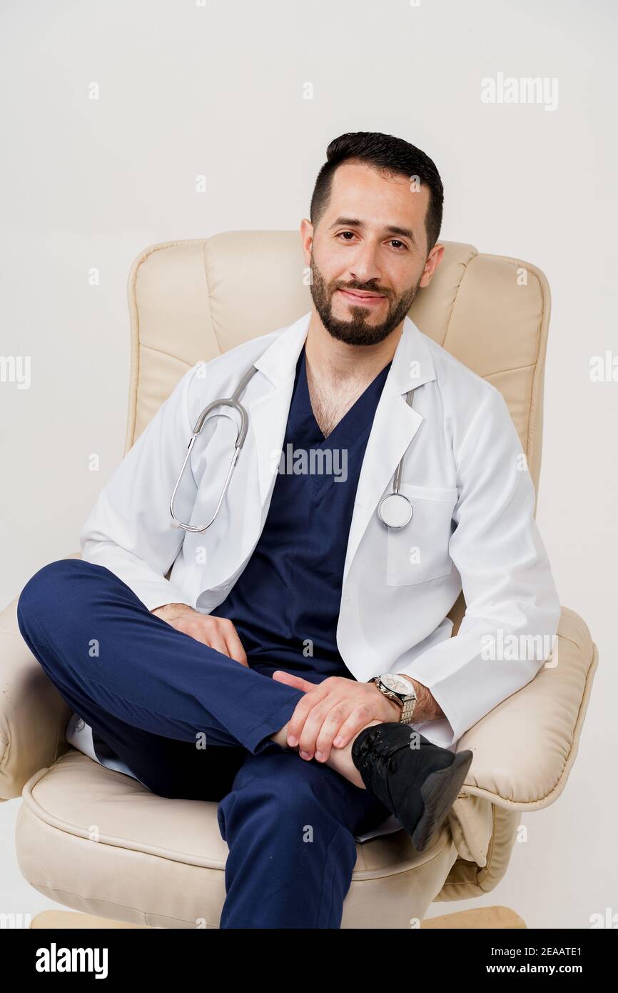 Arabian doctor surgeon in medical robe with phonendoscope seats in ...