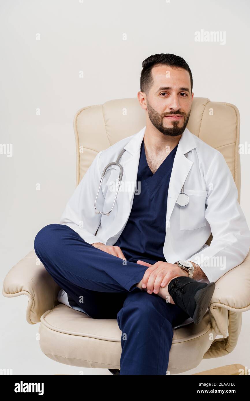 Arabian doctor surgeon in medical robe with stethoscope seats in ...