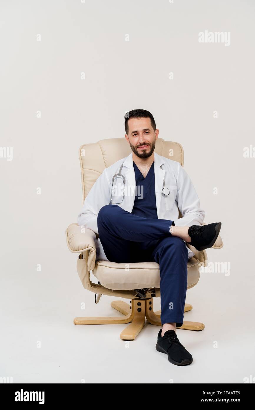 Arabian doctor surgeon in medical robe with stethoscope seats in ...