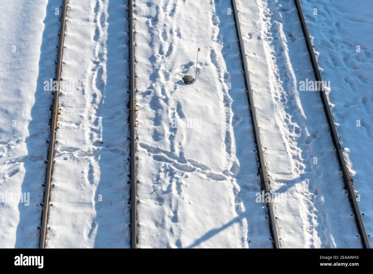 Trains tracks, rails in the snow at sunset, train station Stock Photo ...