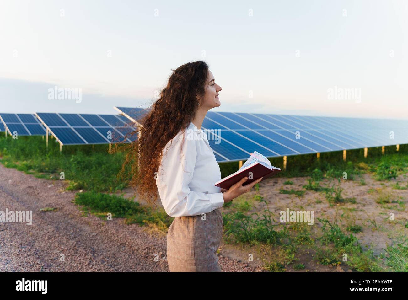 Woman walks near solar hi-res stock photography and images - Alamy