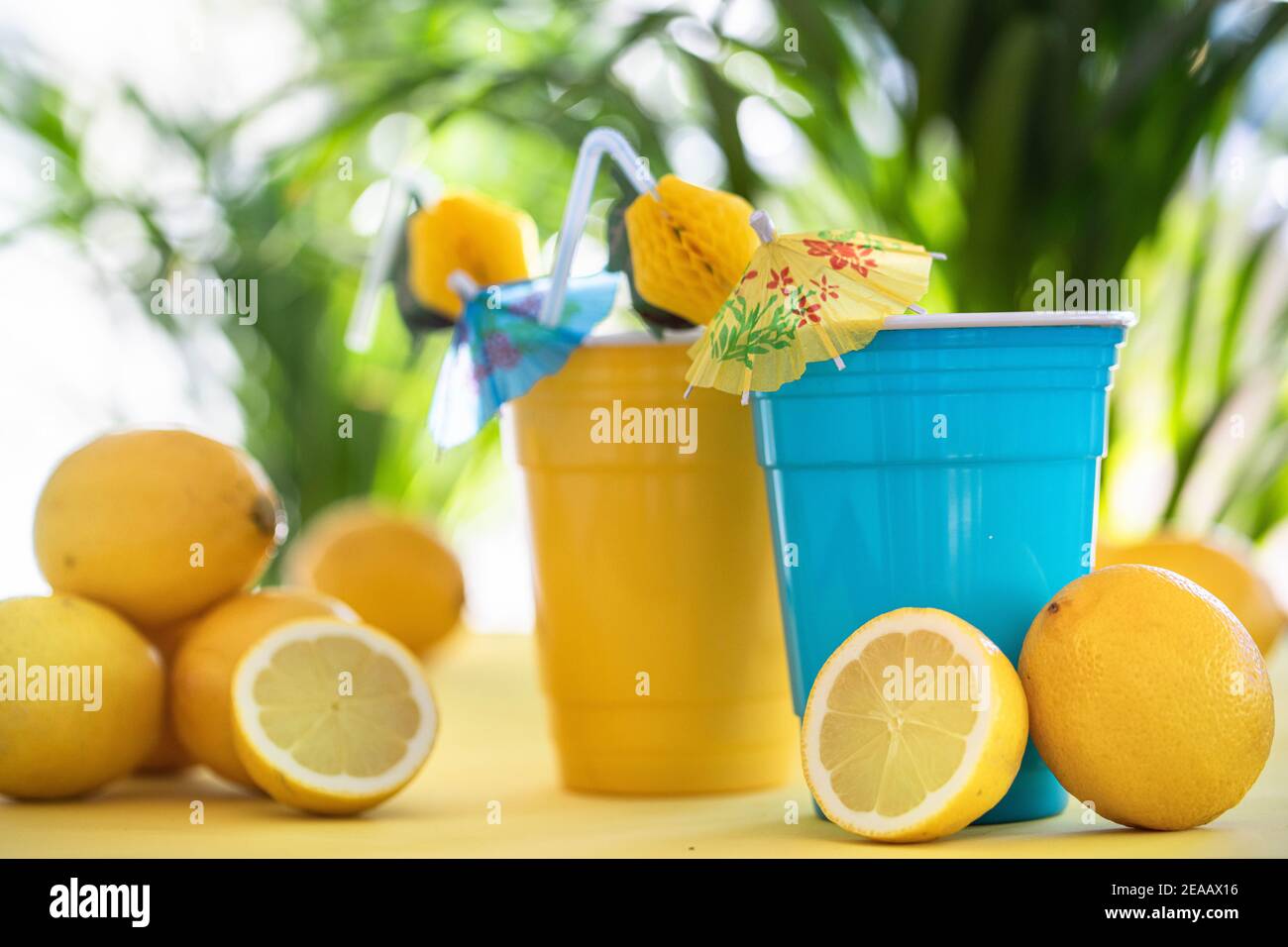 Colourful yellow and blue cups with lemons and straws Stock Photo - Alamy