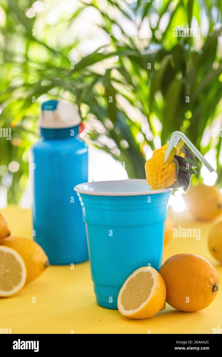 Colourful yellow and blue cups with lemons and straws Stock Photo - Alamy