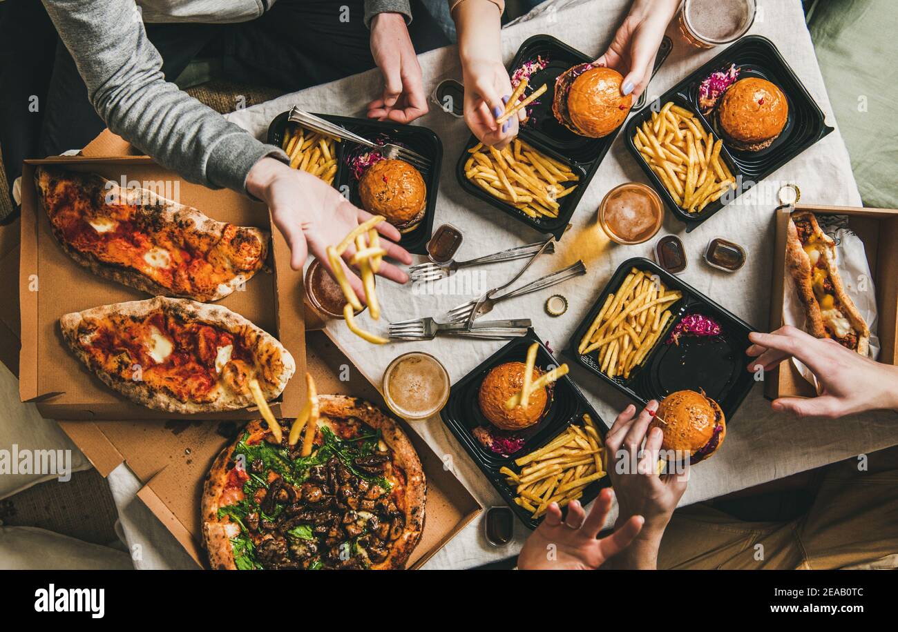 Lockdown fast food dinner from delivery service, getting together. Flat ...