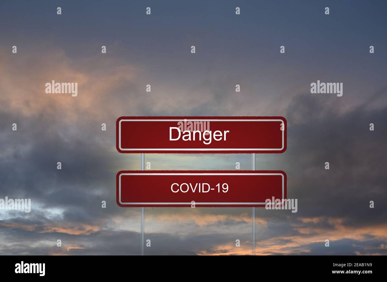 Red Danger Covid-19 sign with stormy sunset sky in the background ...