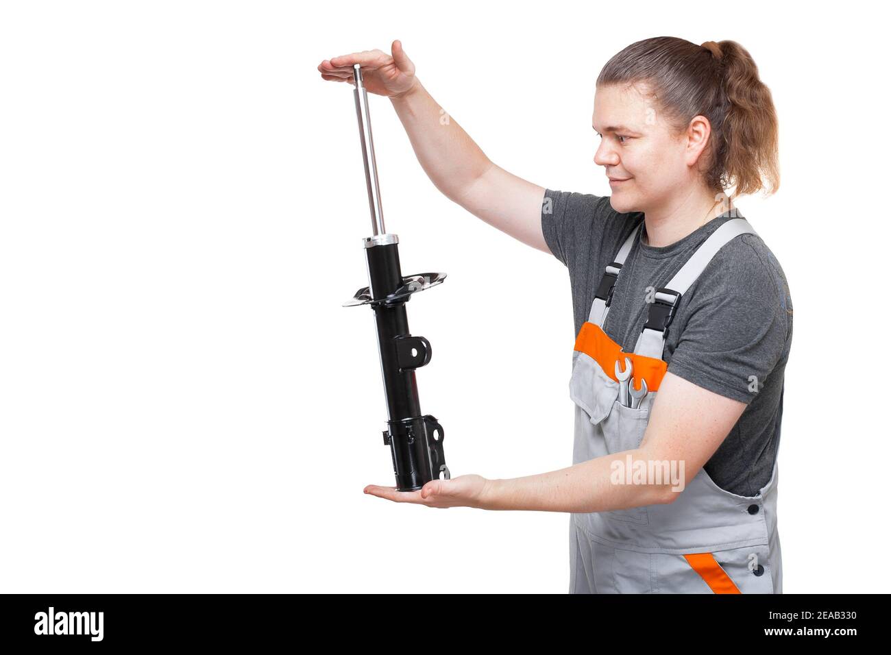 car mechanic in gray uniform with spanner wrench in pocket is holding ...