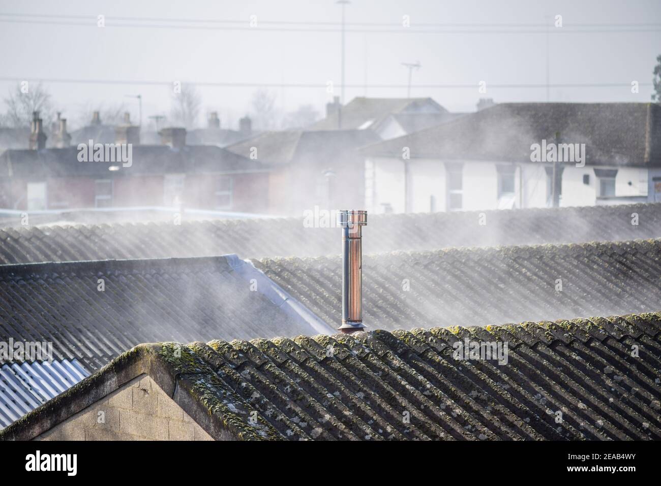 Steaming roofs - evaporation from wet roofs during frosty icy weather ...