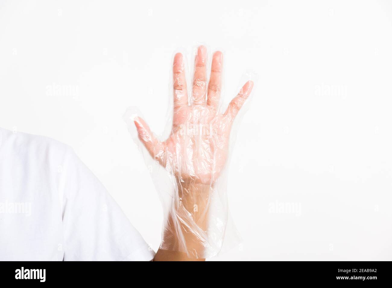Woman hand wearing single use protect disposable transparent plastic ...