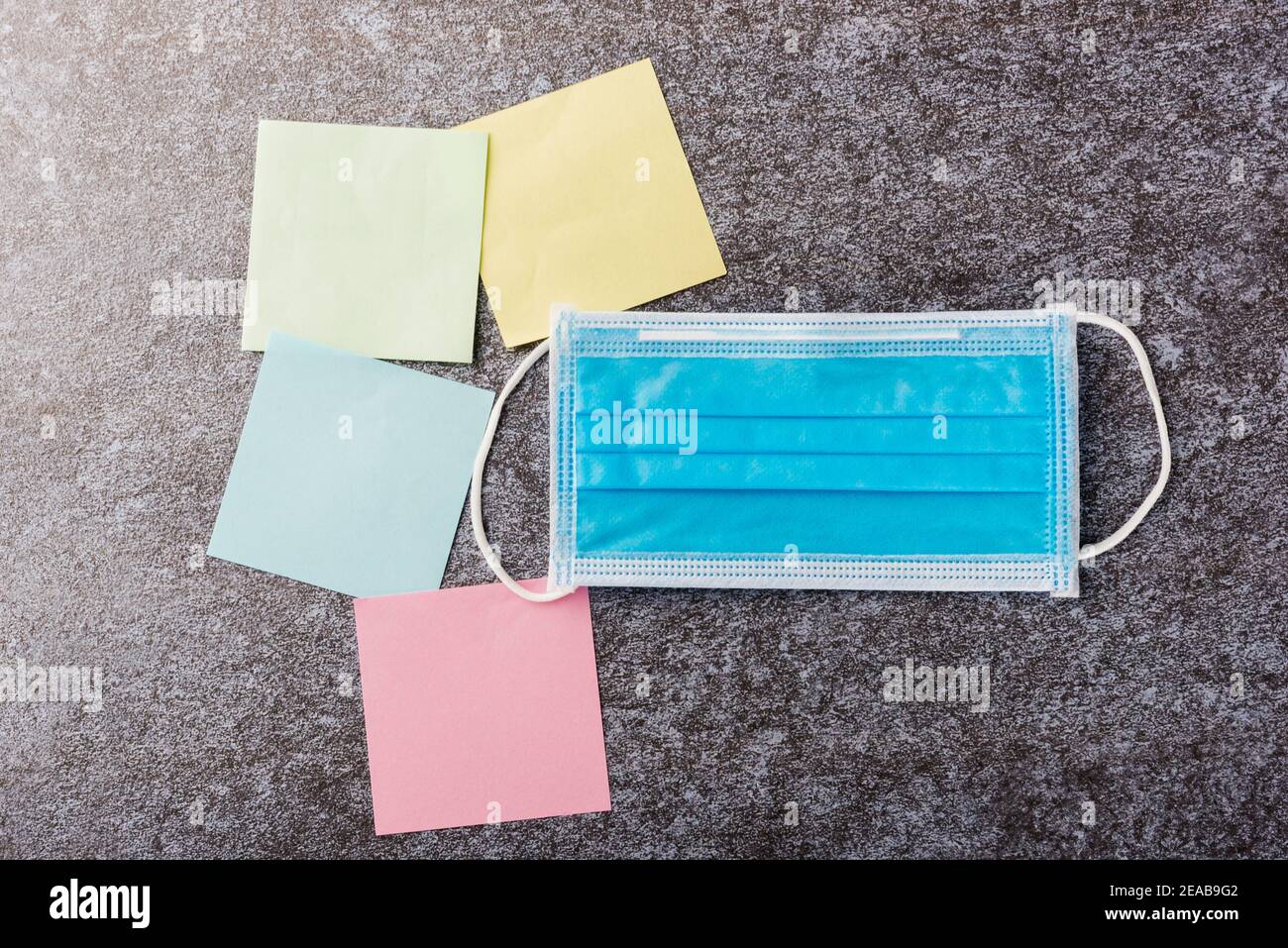 Above blank paper stick note list yellow, green and blue with the face ...