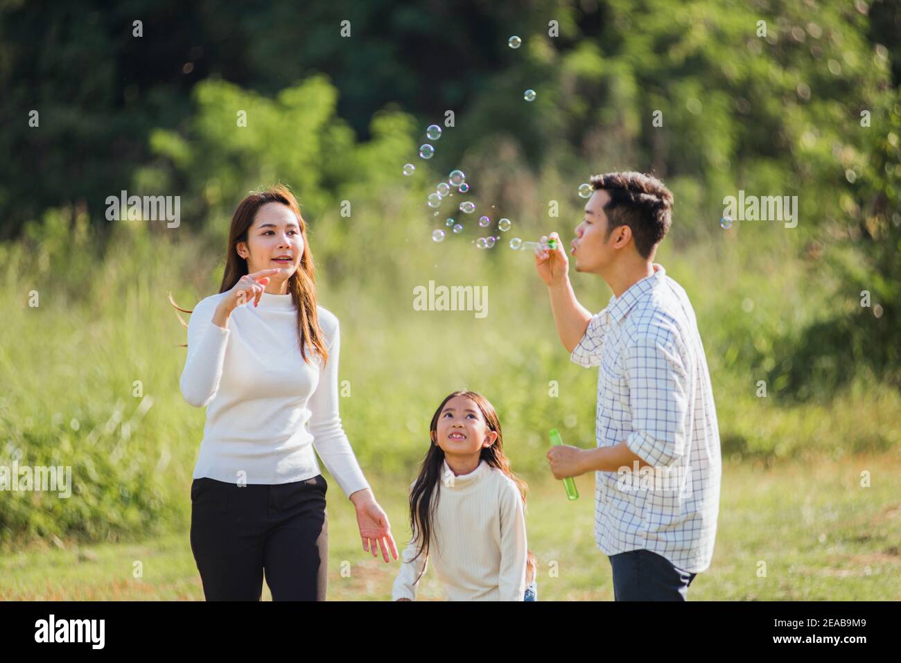 Happy Asian lifestyle family mother, father and little cute girl child ...