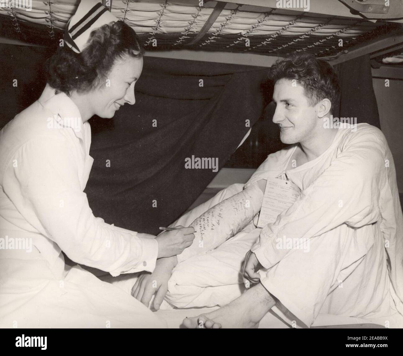 Navy nurse signing cast -- WWII Stock Photo - Alamy