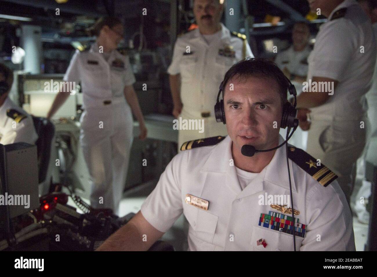 Navy officer works on a scenario in combat information systems aboard ...