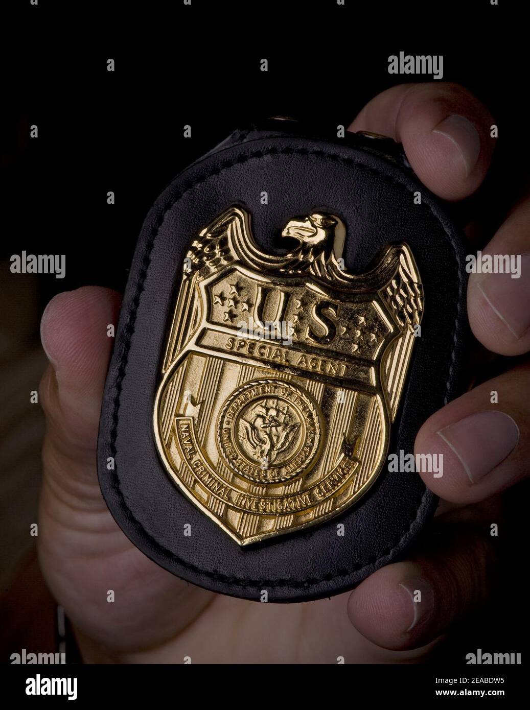 NCIS Badge in hand Stock Photo - Alamy
