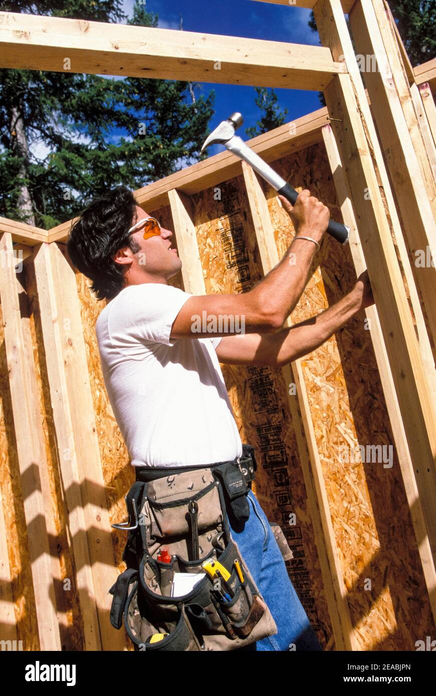 A construction worker framing a home under construction Stock Photo - Alamy