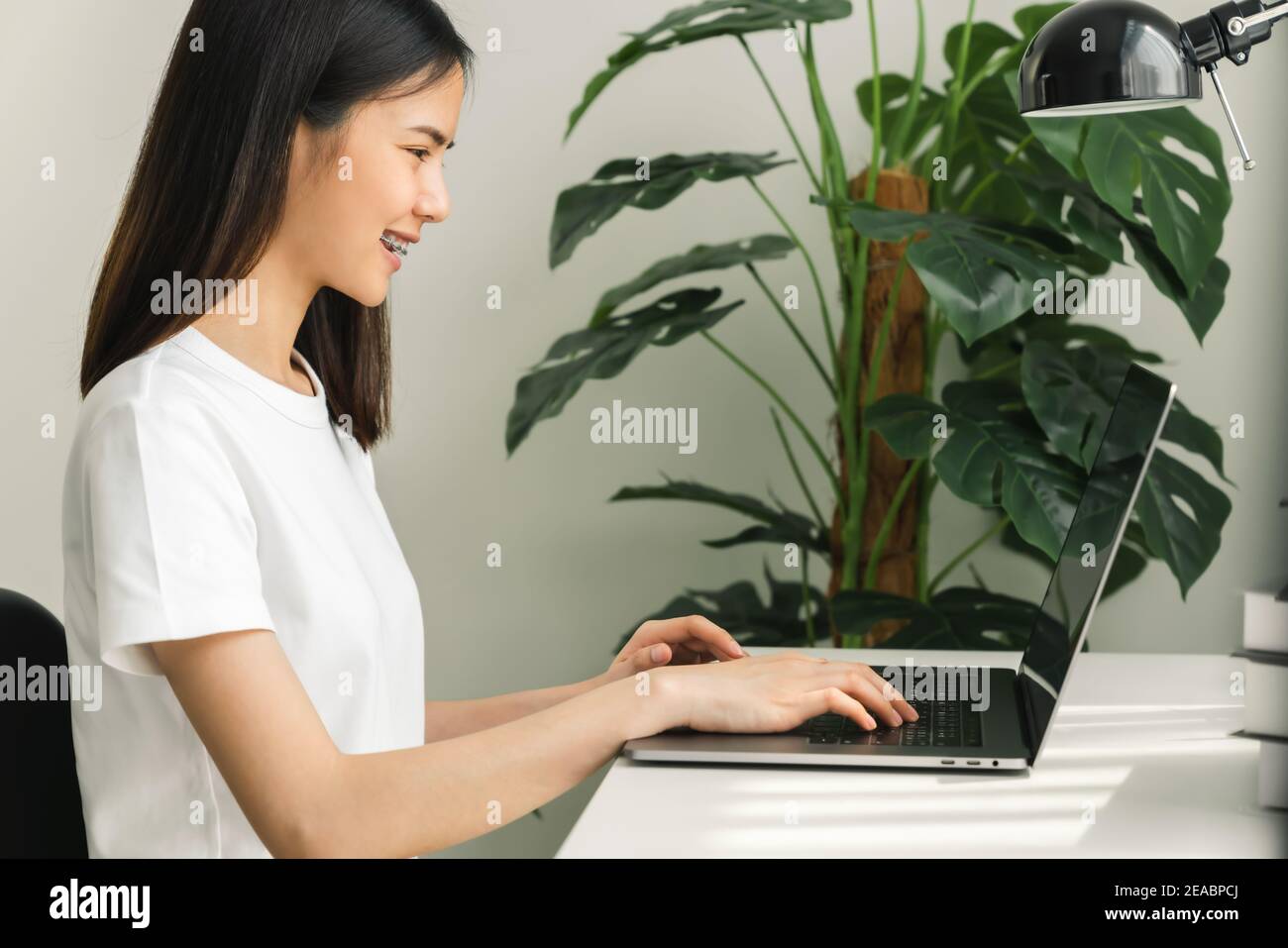Woman hand using laptop on the table in house, mock up of blank screen ...
