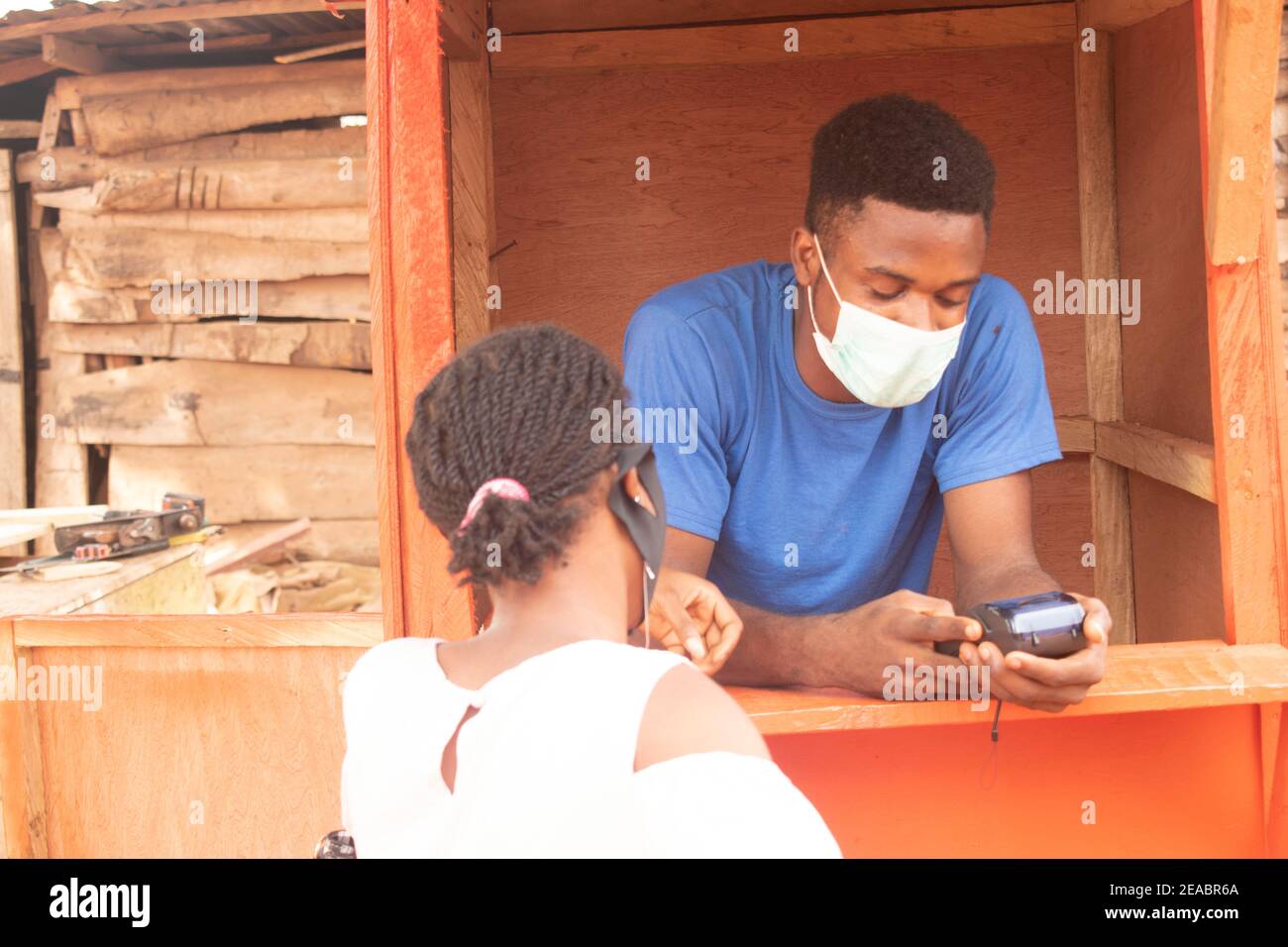 a young african businessman using a pos machine Stock Photo - Alamy