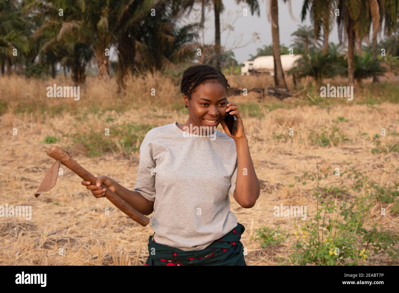 an african woman making a phone call at a farmland Stock Photo - Alamy