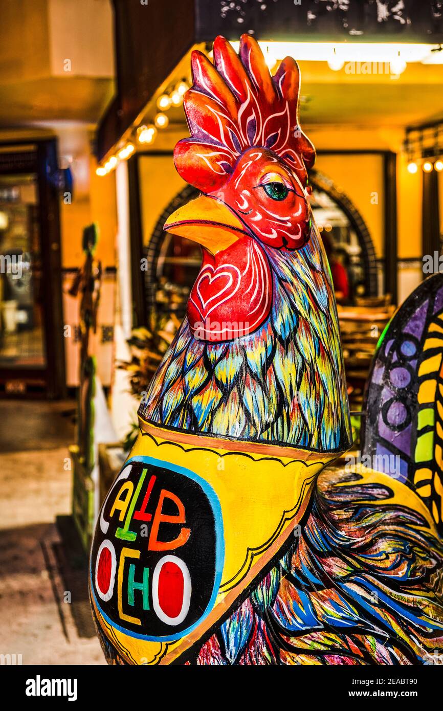 A colorful rooster statue painted with multicolor diamonds and Calle ...