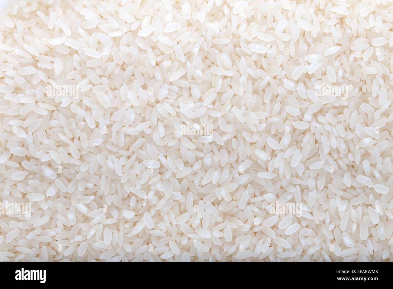Uncooked white rice background. Background and texture Stock Photo - Alamy