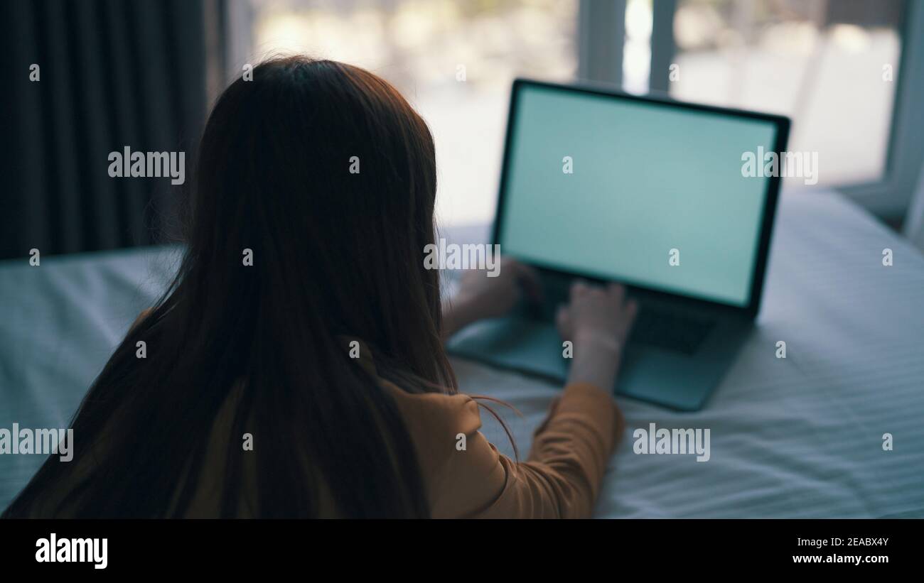 woman lying on bed working in front of laptop at home internet Stock ...