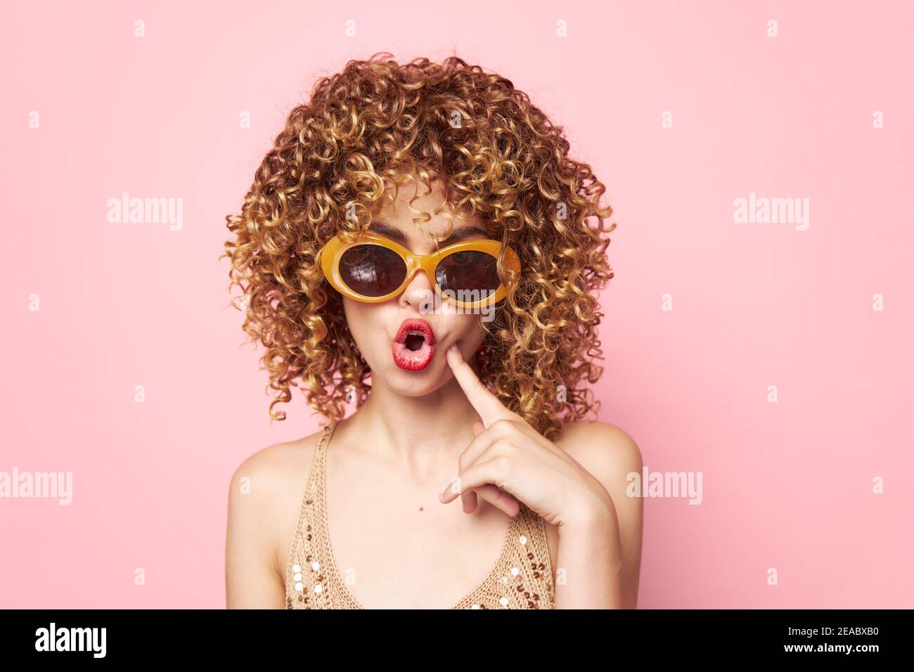 Model Curly hair grimace dark sunglasses pink background fashion ...