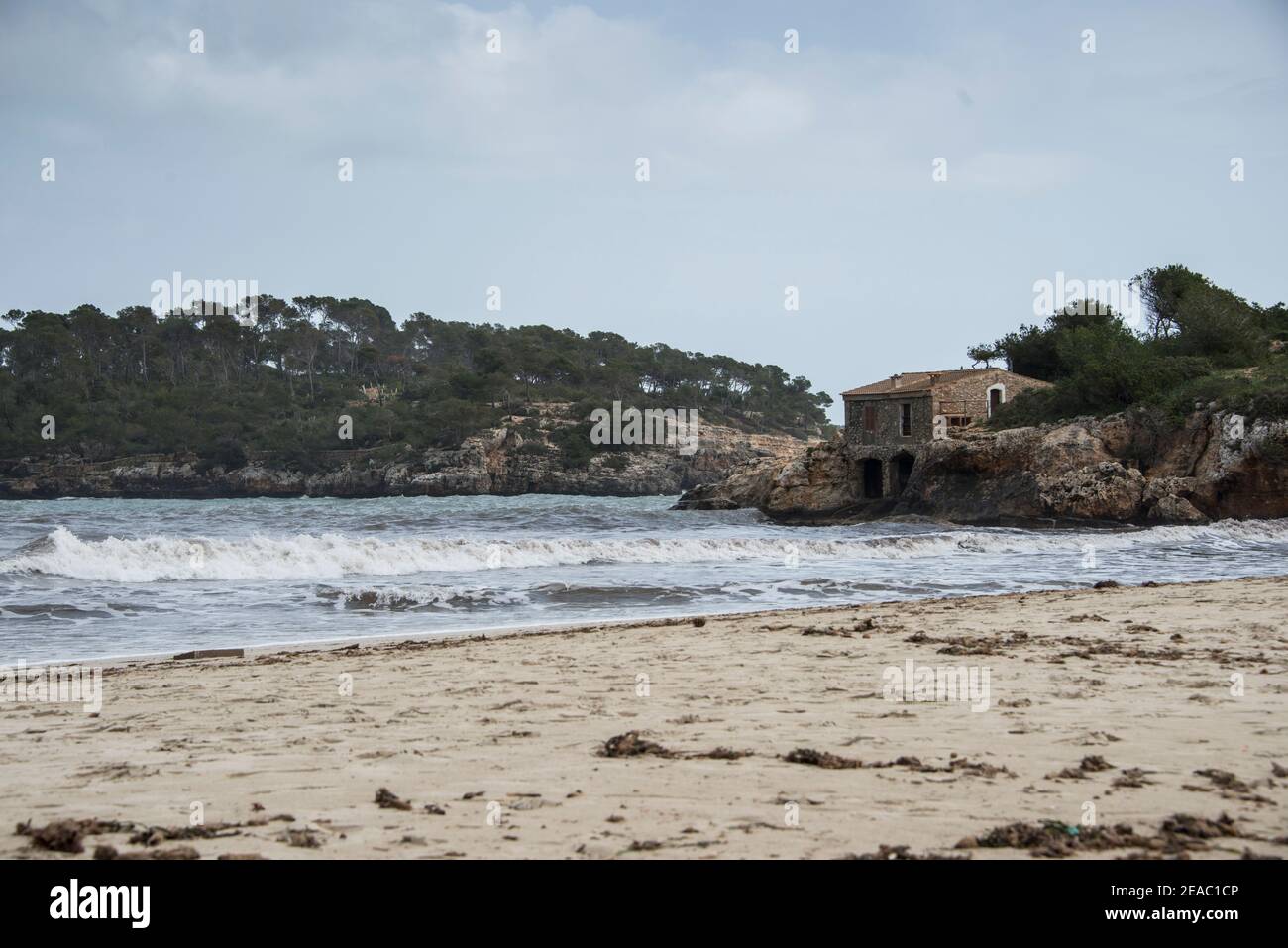 Sandy beach with house on the rocks, Mallorca Stock Photo - Alamy