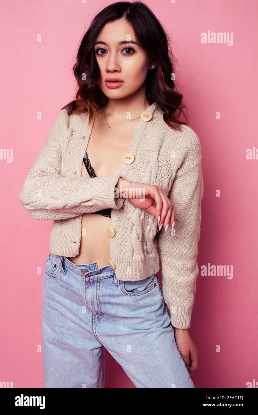 young pretty girl with curly hair posing cheerful on pink background ...