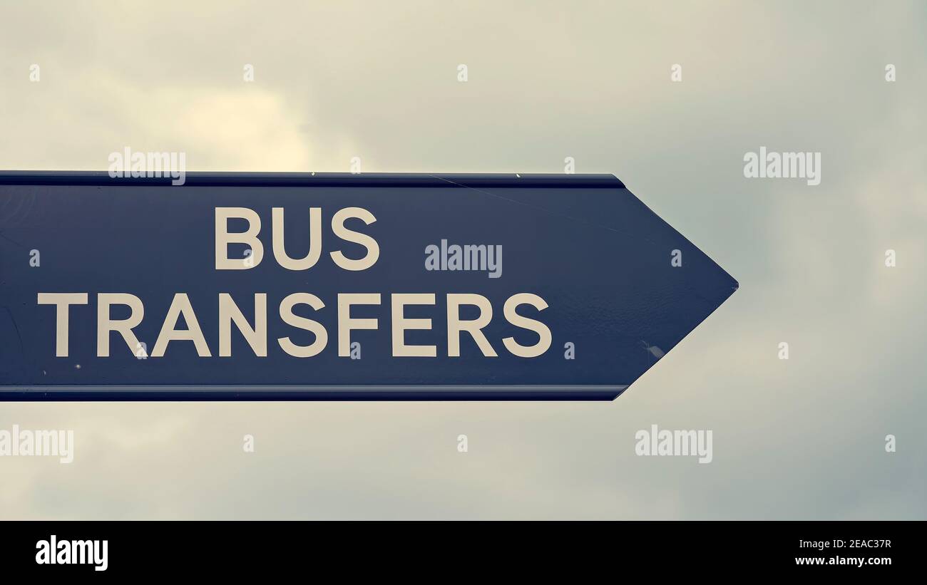 Bus Transfers signage arrow against grey background Stock Photo - Alamy