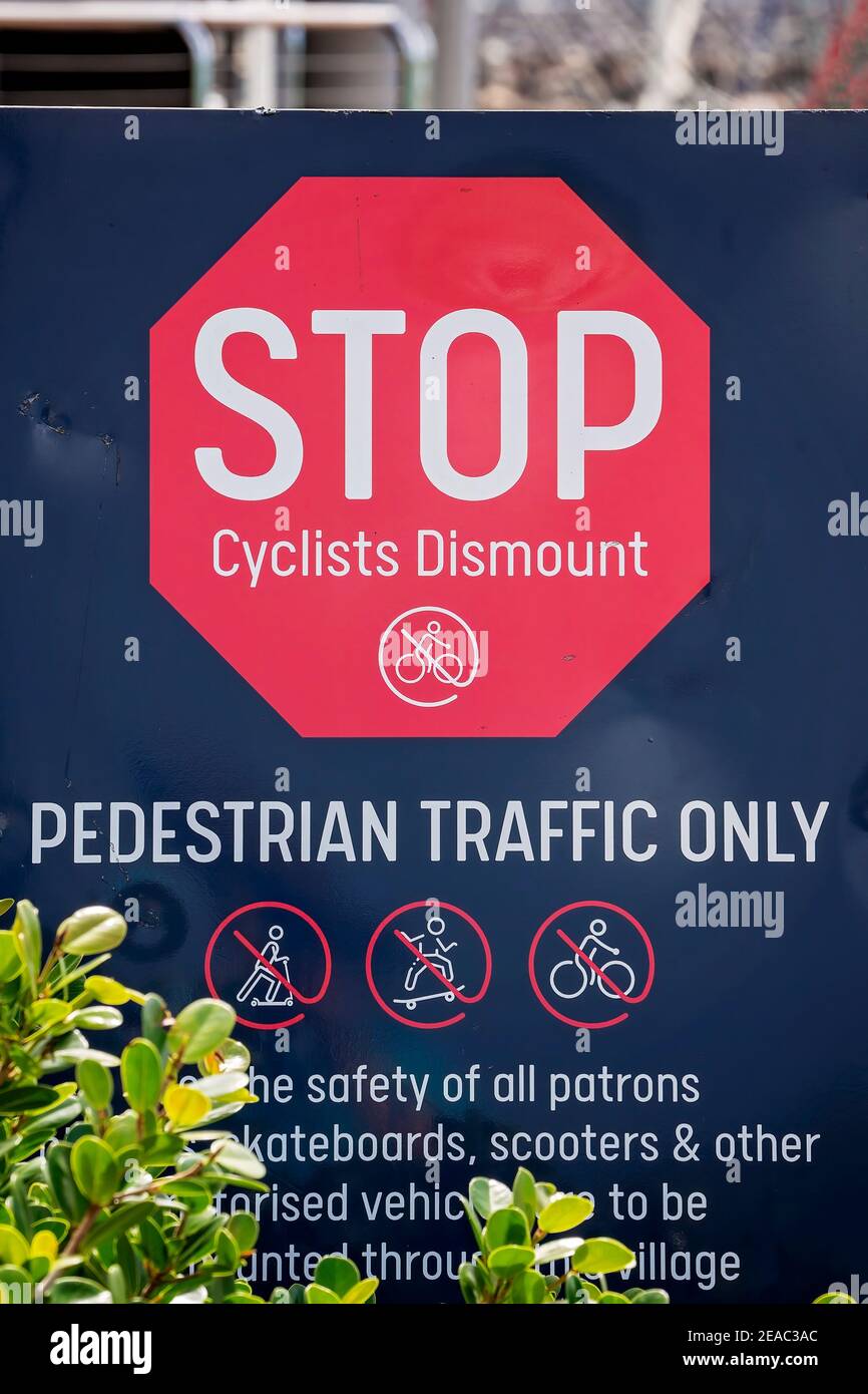 Pedestrian traffic only signage indicating cyclists must stop and ...