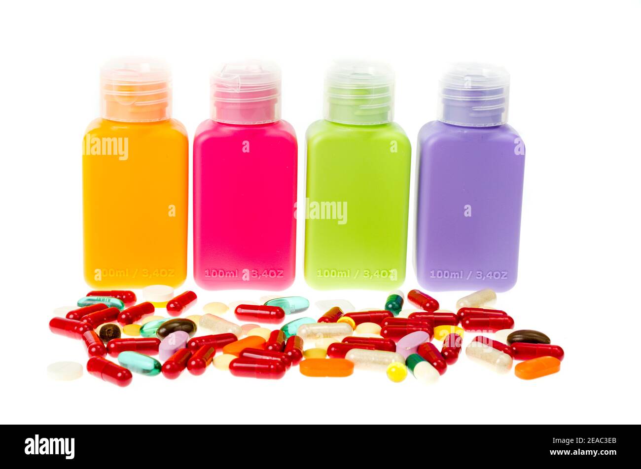 Multi-colored plastic bottles, containers with pills and capsules ...