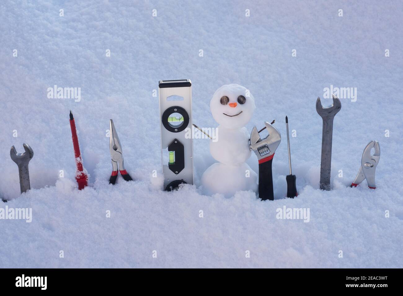Repairing tools. Snowman with repairing instrument. Snow man worker ...