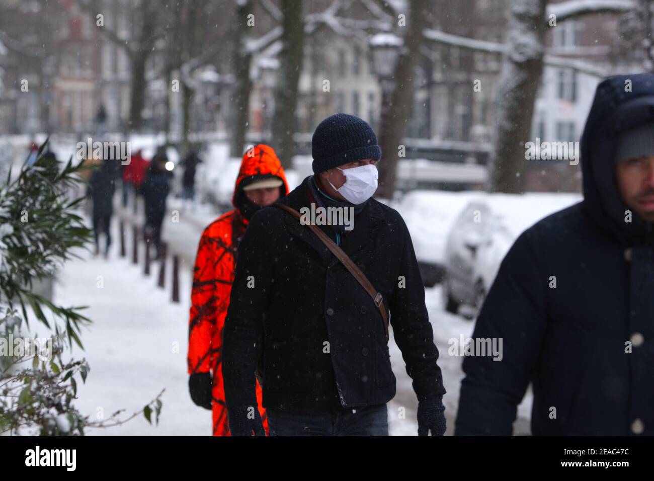 Members of the public walks through the snow on the street on February ...