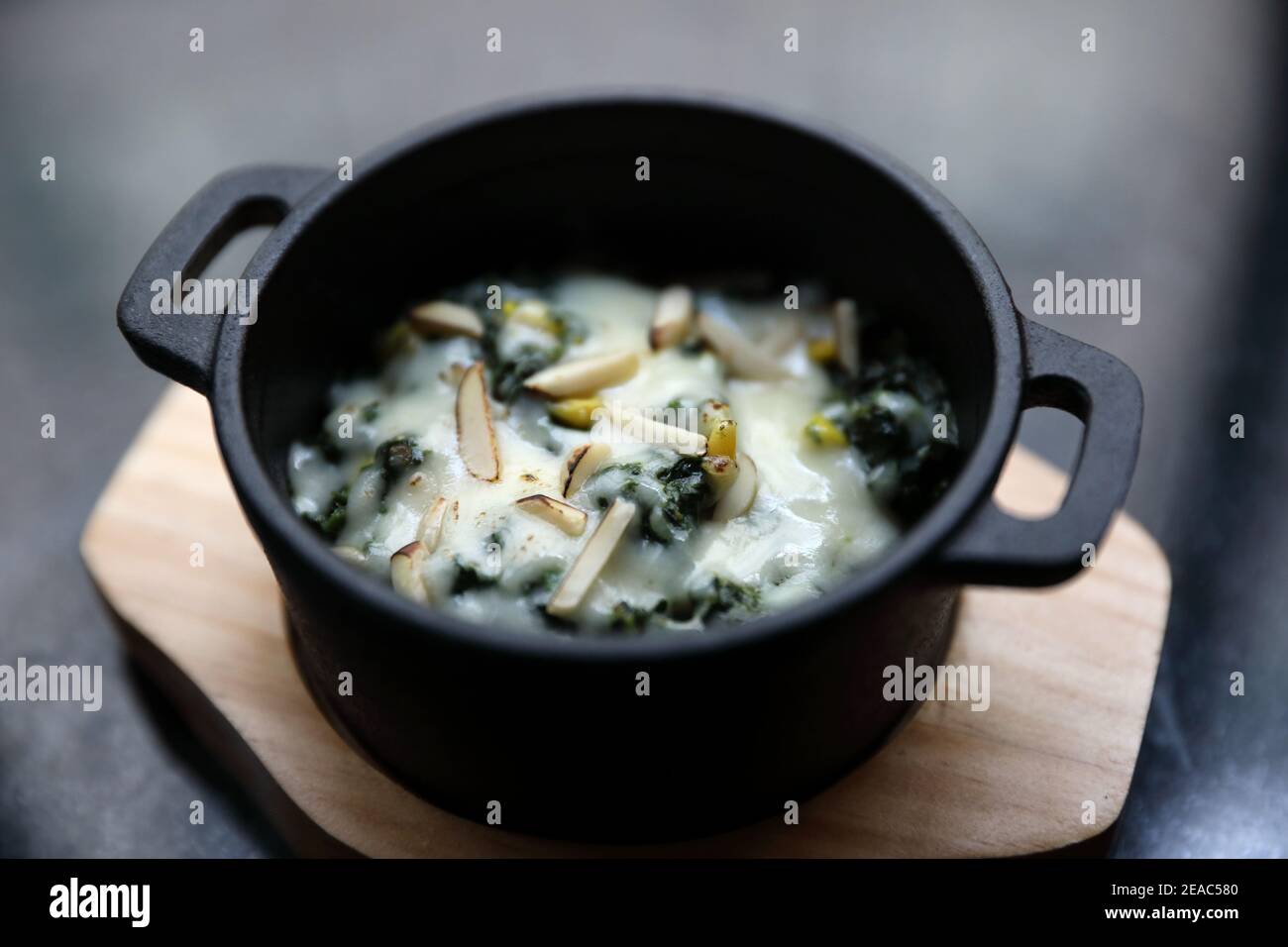 Spinach Cheese Bake on wooden plate apptizer Stock Photo - Alamy