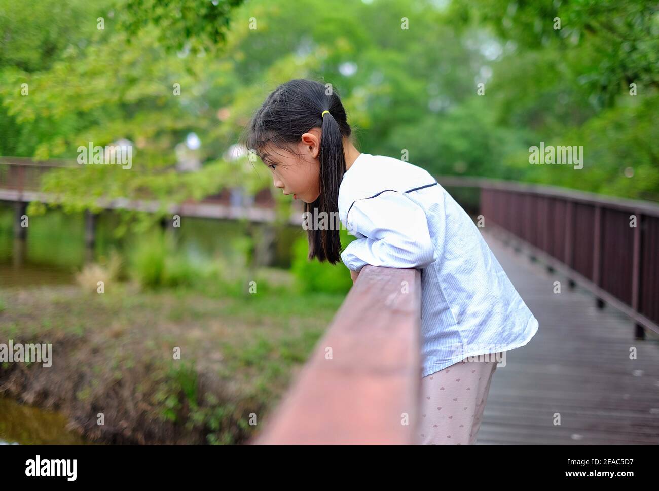 Child leaning on railings hi-res stock photography and images - Alamy