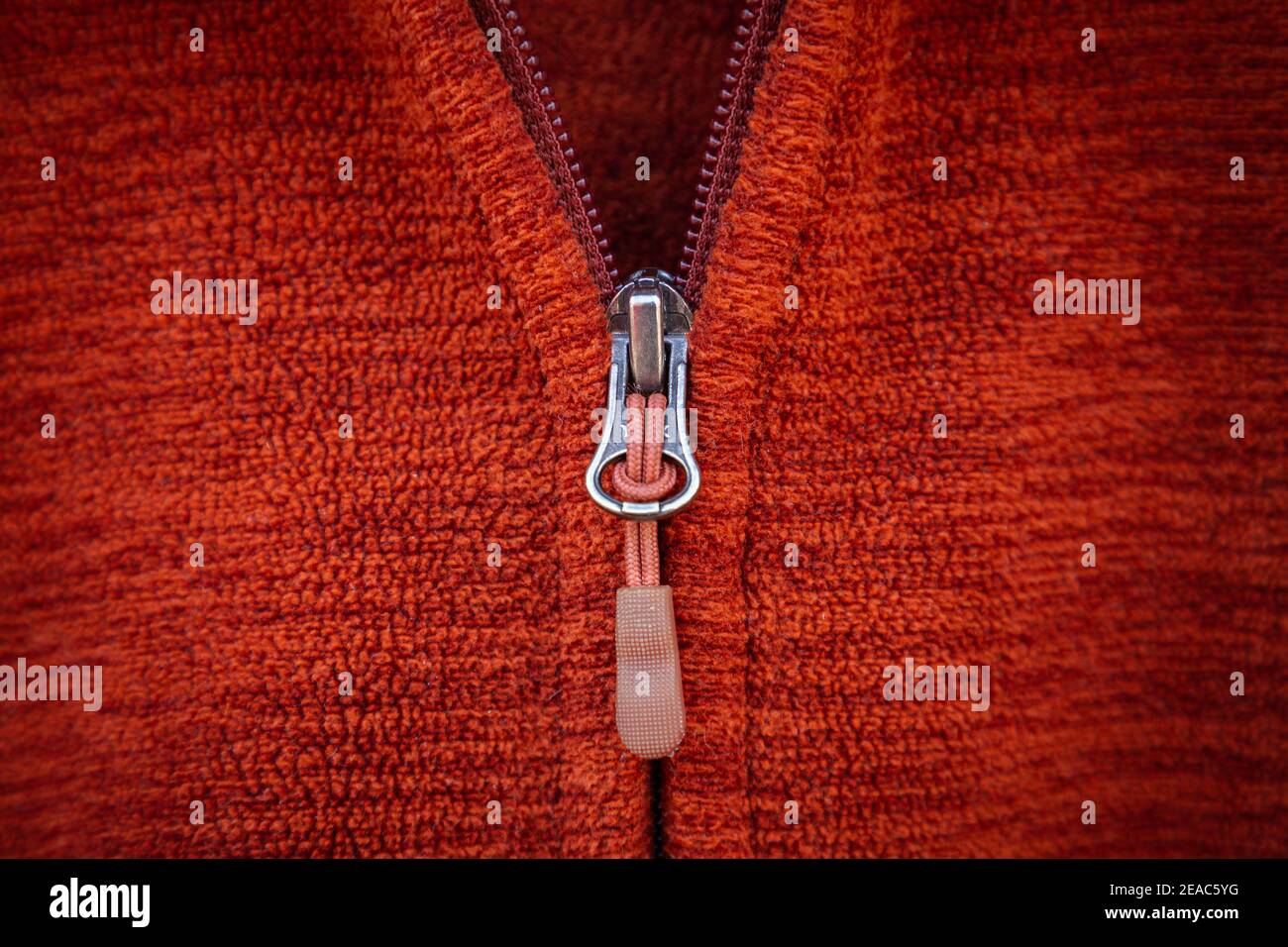 Zip zipper close up macro on red clothes background Stock Photo - Alamy
