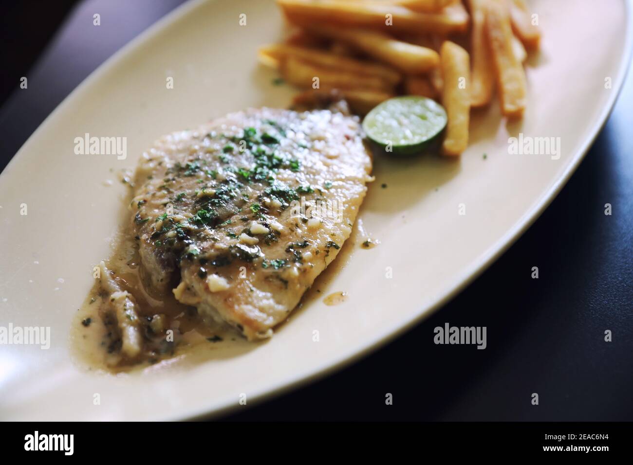Halibut fillet steak with chips Stock Photo - Alamy
