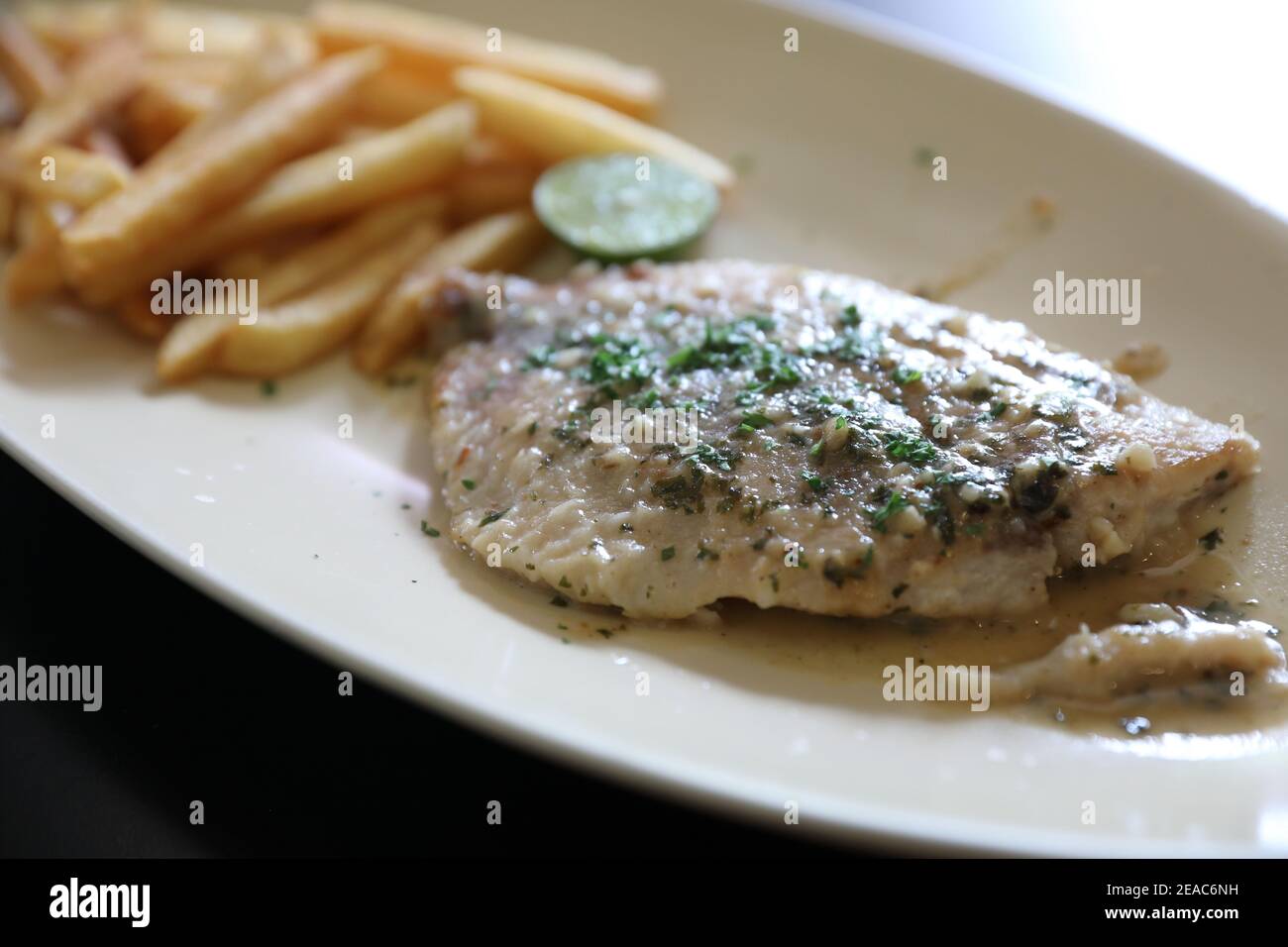 Halibut fillet steak with chips Stock Photo - Alamy