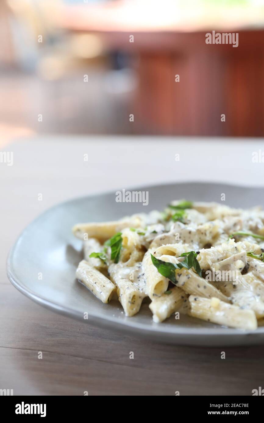 Penne pasta with white sauce and truffle , italian food Stock Photo - Alamy