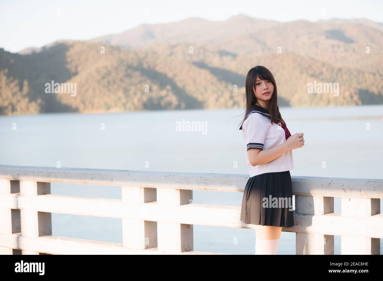 Portrait of Japanese school girl uniform smile with walkway and river ...