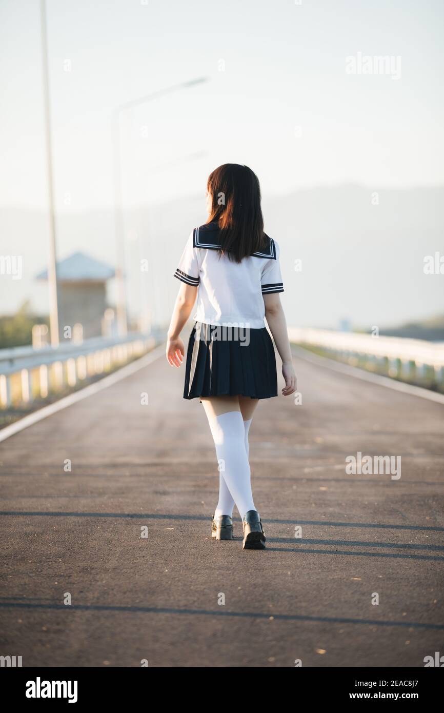 Portrait of Japanese school girl uniform smile with walkway and river ...