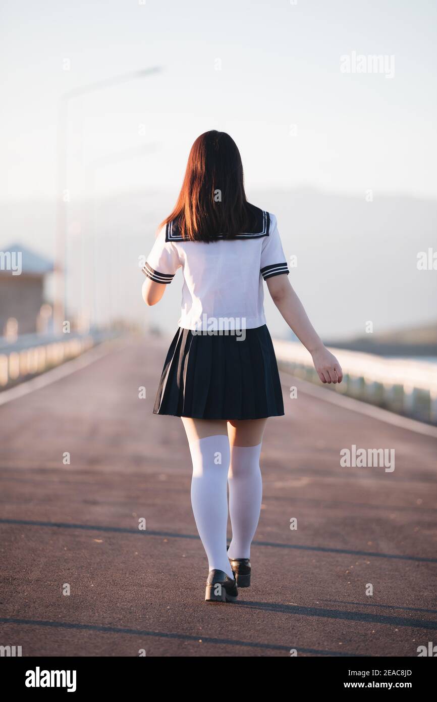 Portrait of Japanese school girl uniform smile with walkway and river ...